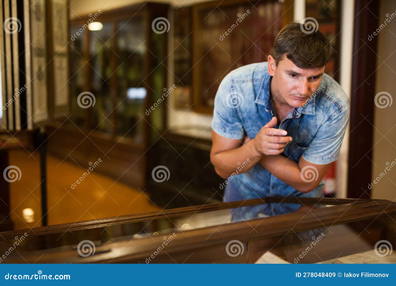 Man Looking at Exhibits in Glazed Stands Stock Image - Image of leisure ...