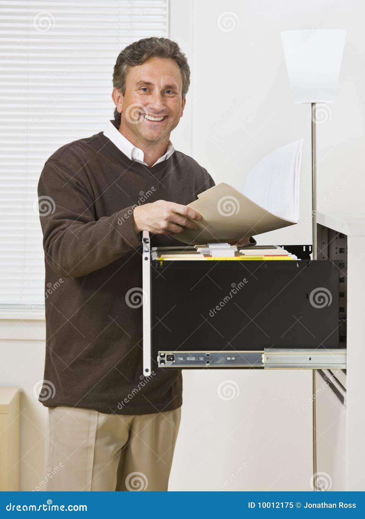 Man Looking through Files stock image. Image of office - 10012175