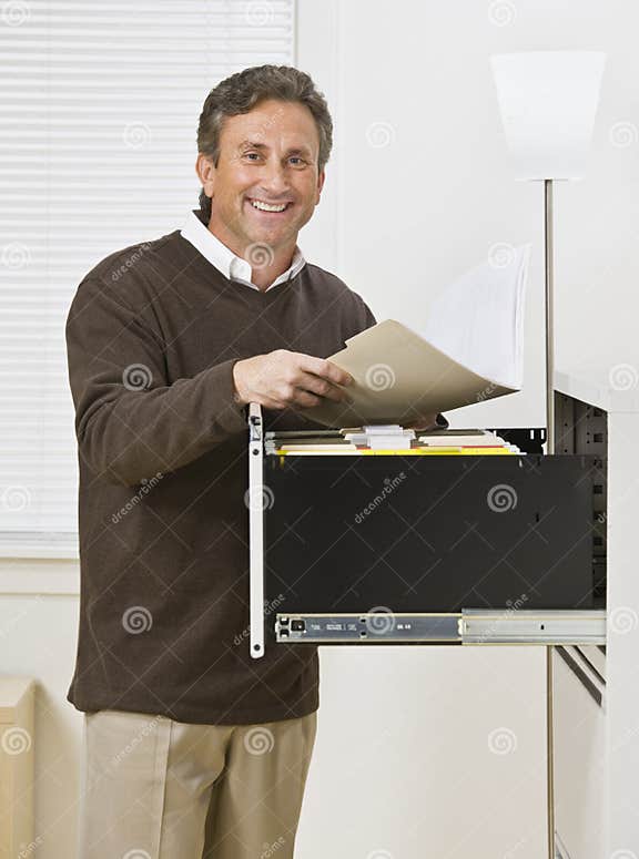 Man Looking through Files stock image. Image of office - 10012175