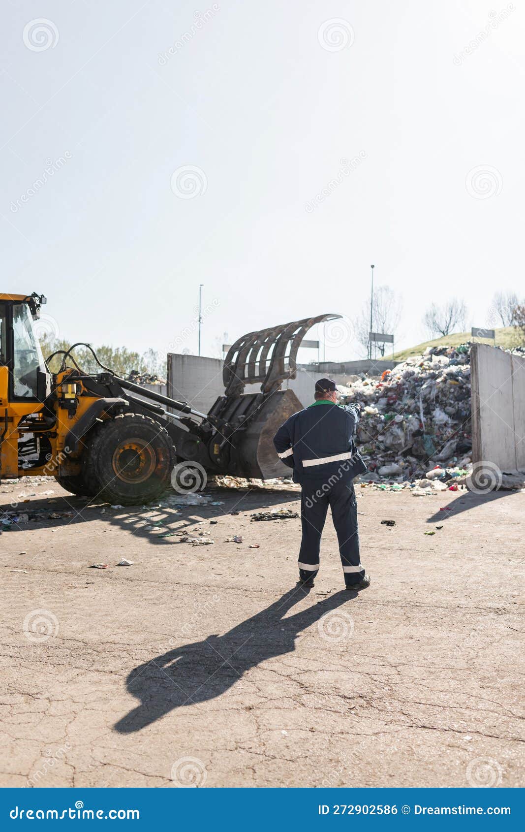 Man Looking at Garbage at Landfill Stock Photo - Image of machine ...