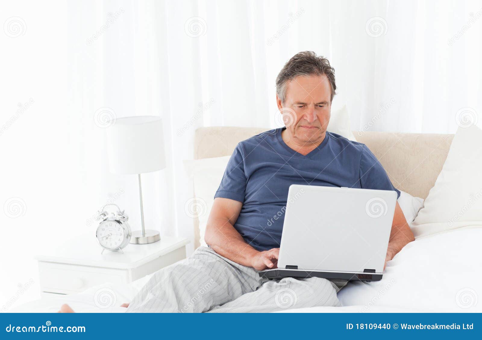 Man looking at his laptop stock photo. Image of male - 18109440