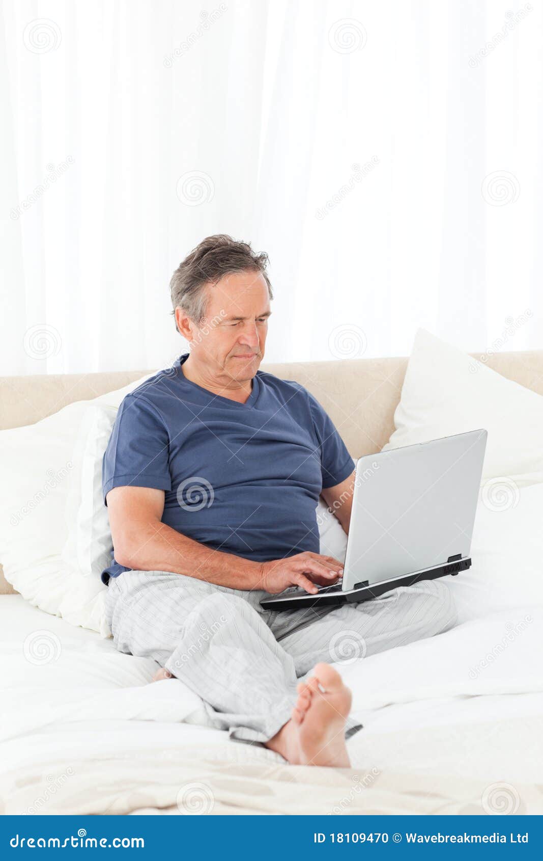 Man looking at his laptop stock photo. Image of room - 18109470