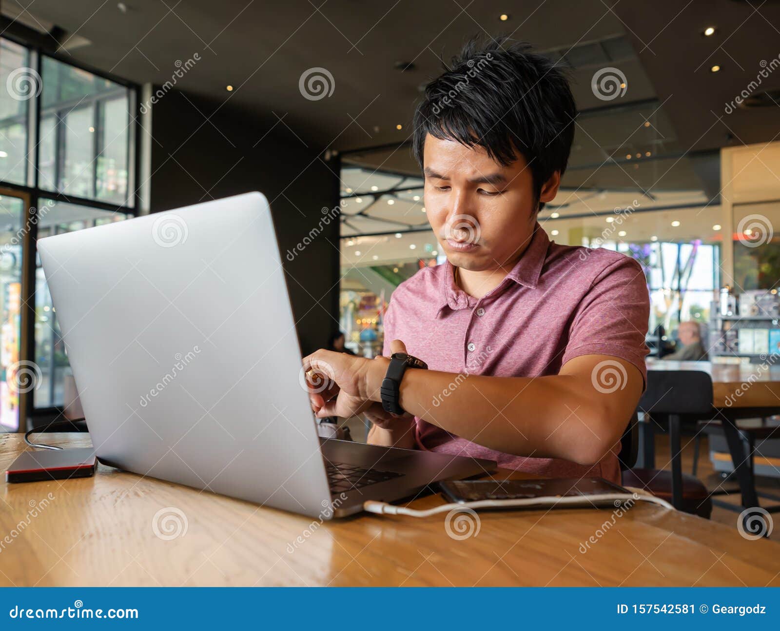 Man is Looking His Smart Watch with Laptop Computer in Cafe Stock Image ...