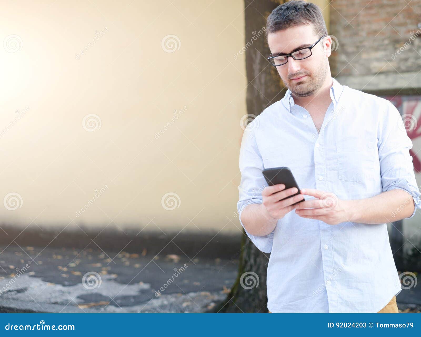 Man looking his smartphone stock image. Image of careless - 92024203