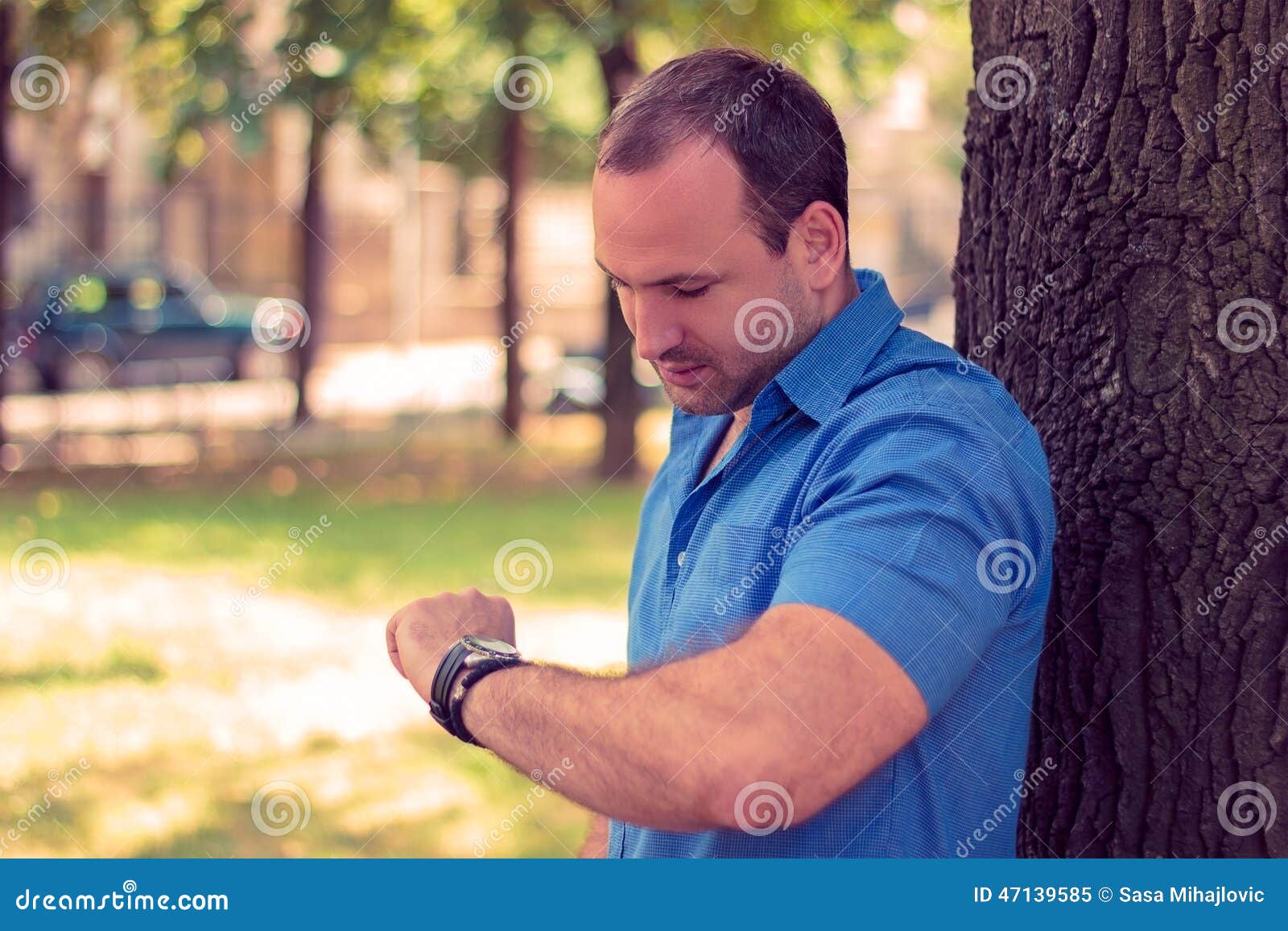 Man looking at his watch stock image. Image of clock - 47139585