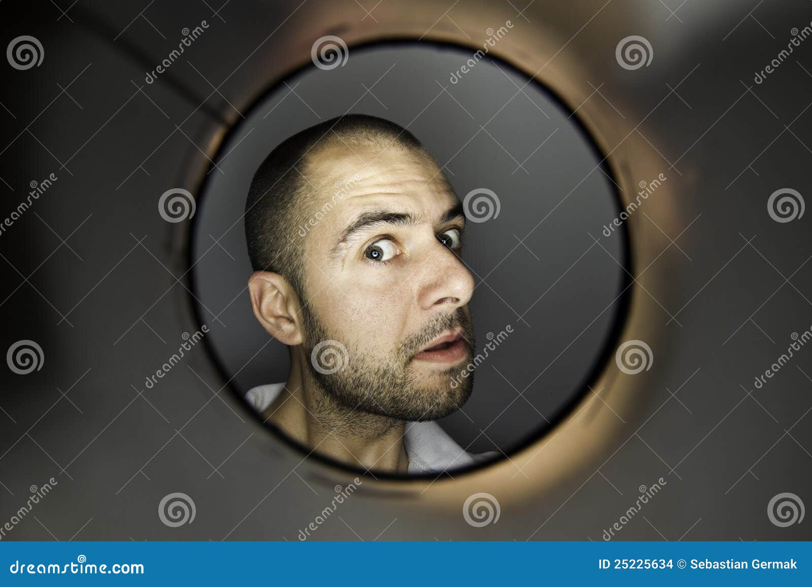 Man looking at a hole stock photo. Image of gazing, hide - 25225634