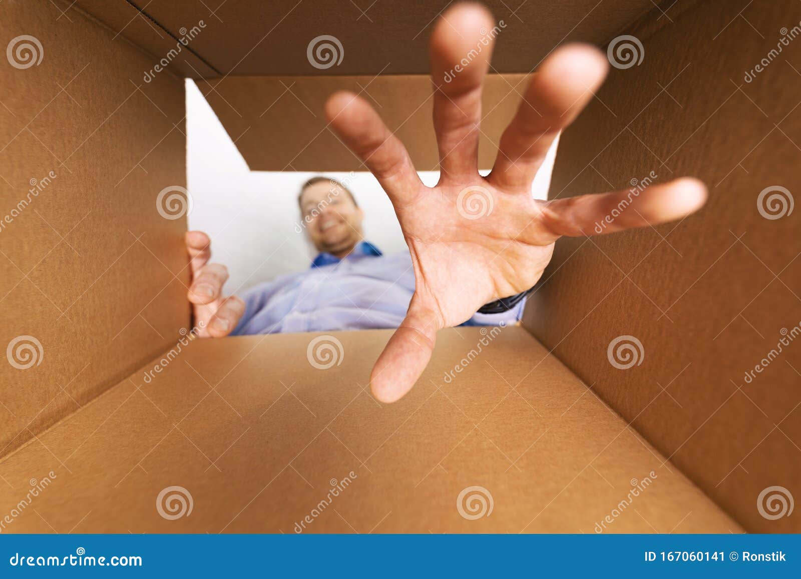 Man Looking Inside the Box and Reaching for Goods Stock Image - Image ...