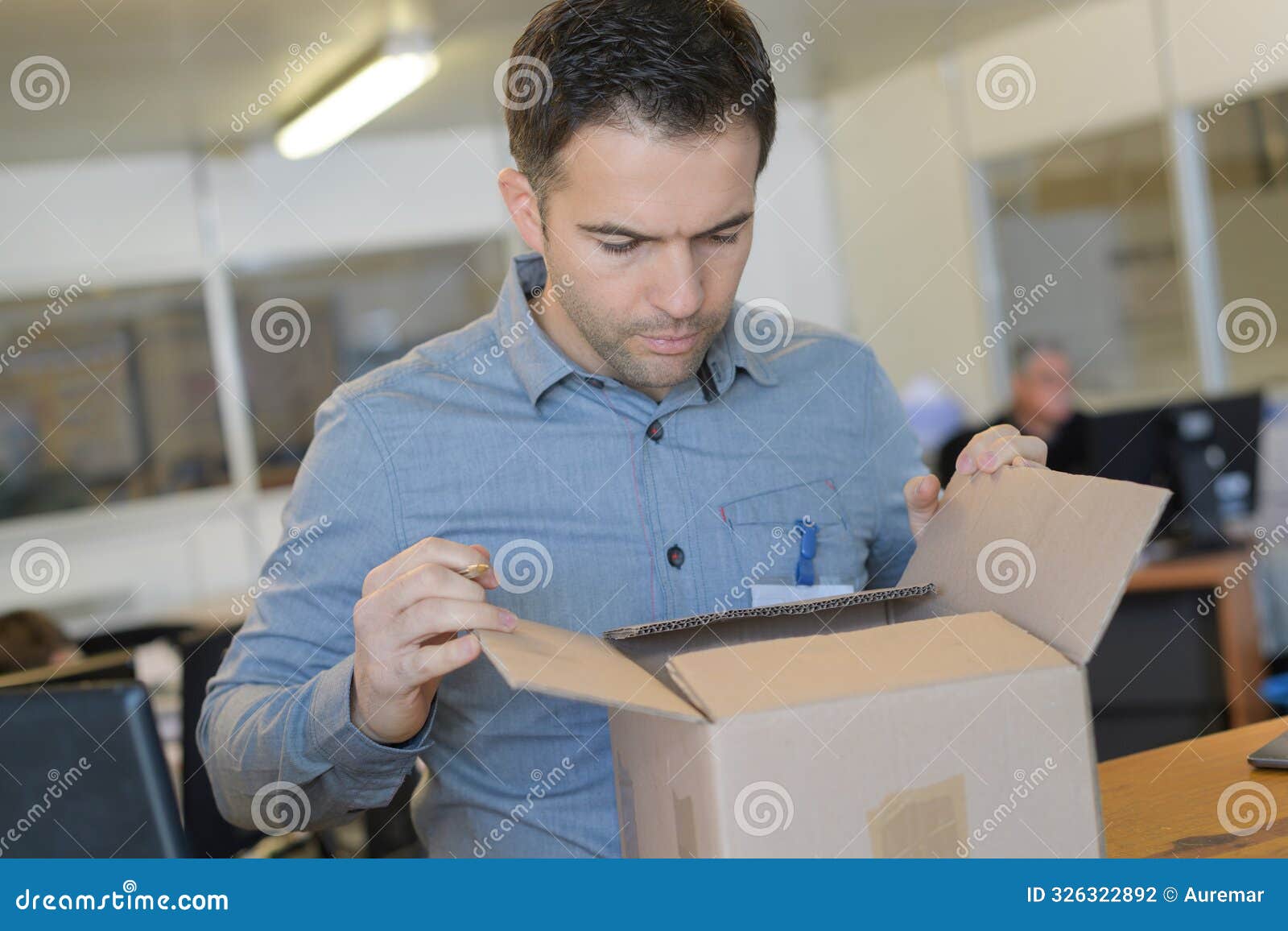 Man Looking Inside Cardboard Box in Workplace Stock Photo - Image of ...