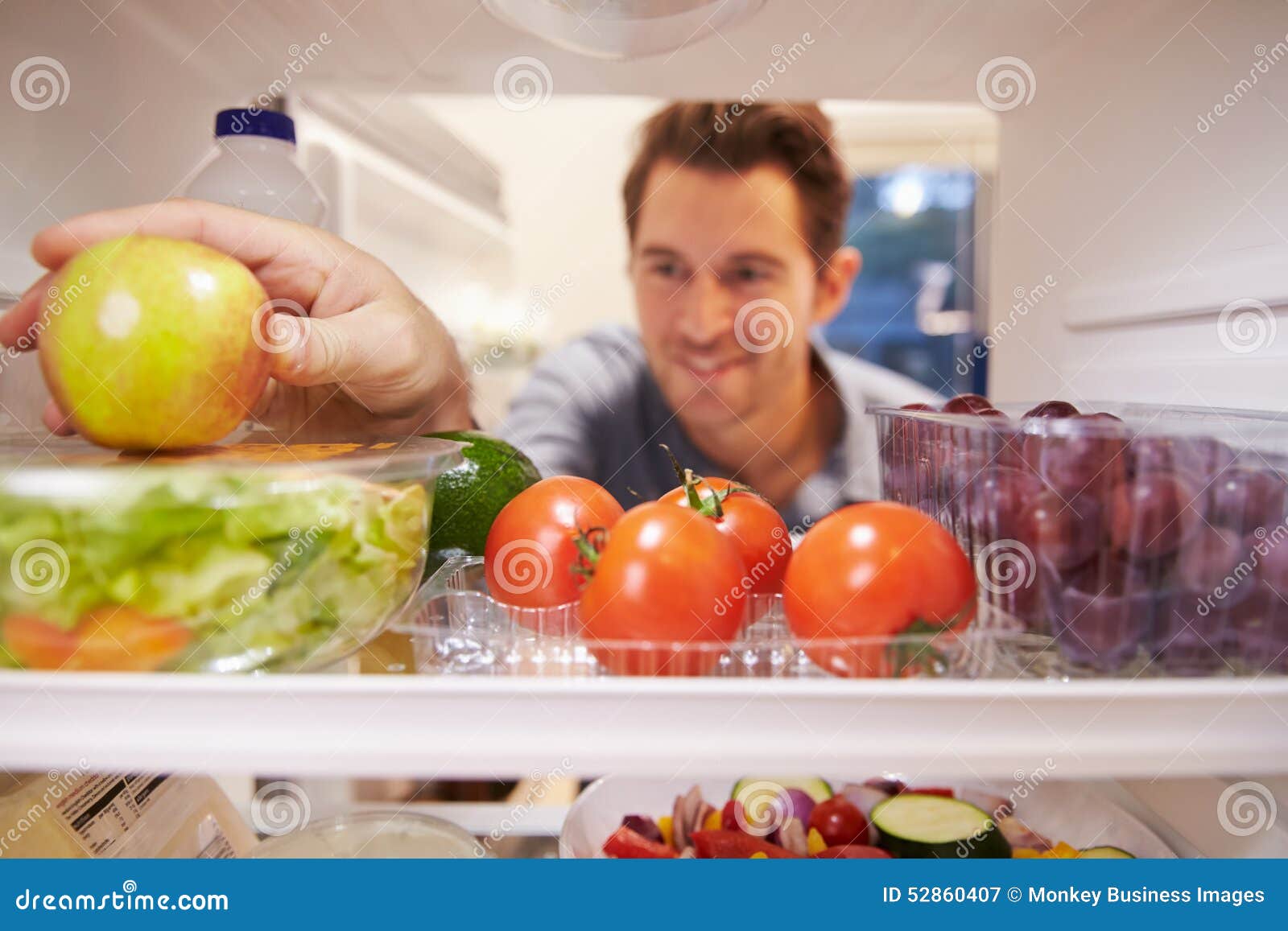 Man Looking Inside Fridge Full of Food and Choosing Apple Stock Image ...