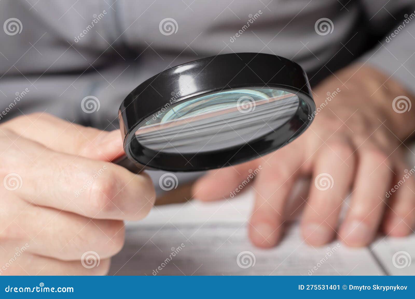 Man Looking through a Magnifying Glass To Documents Stock Image - Image ...