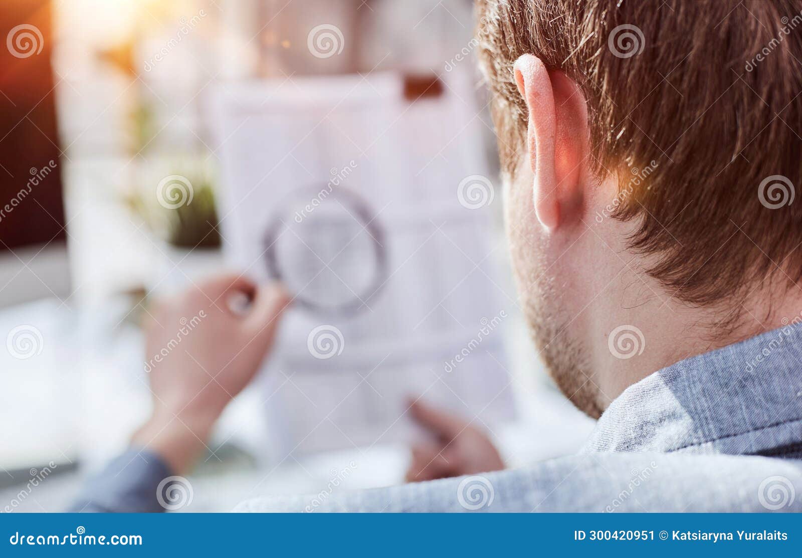 Man Looking through a Magnifying Glass To Documents Notebook. Stock ...
