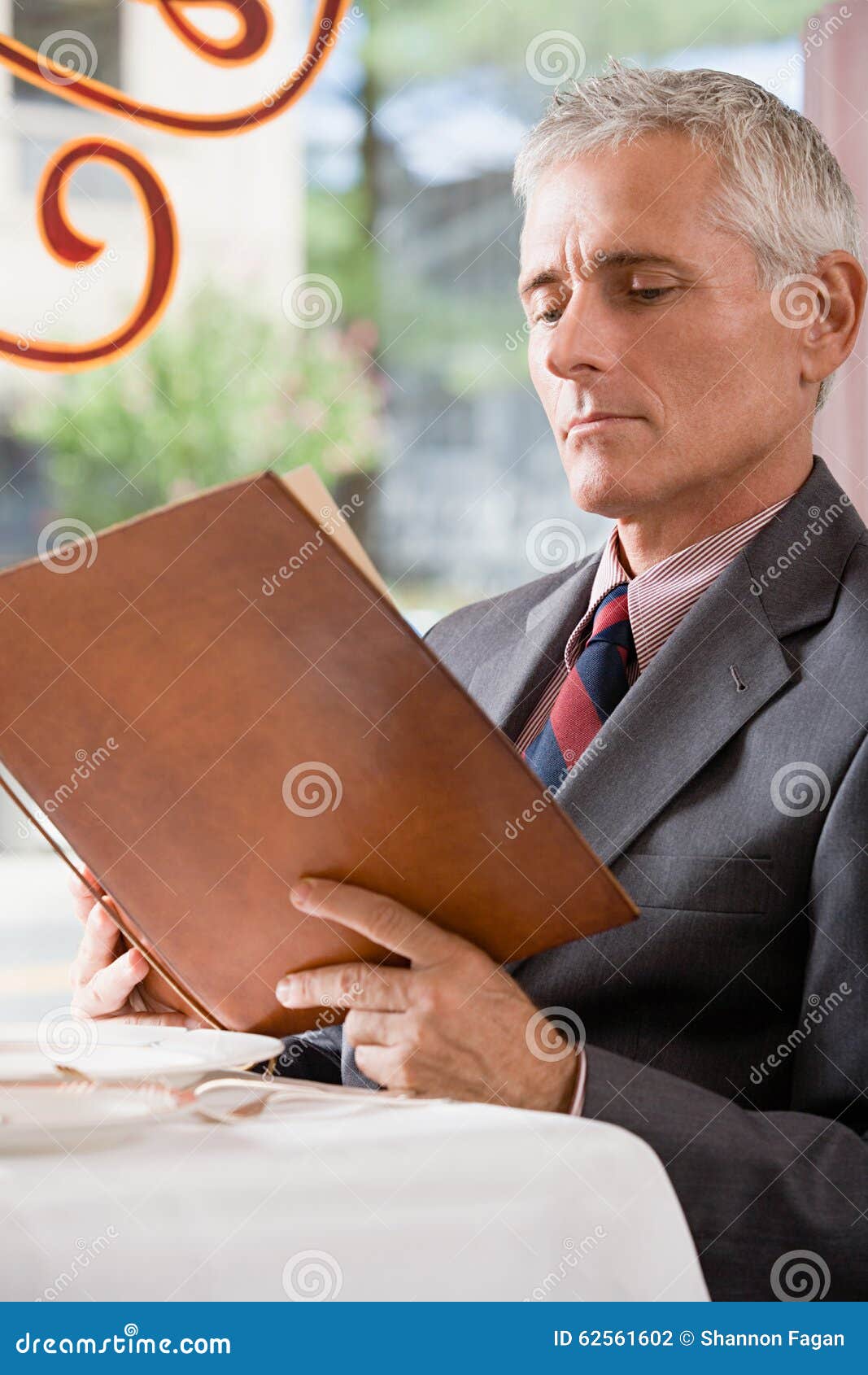 Man looking at a menu stock photo. Image of happiness - 62561602