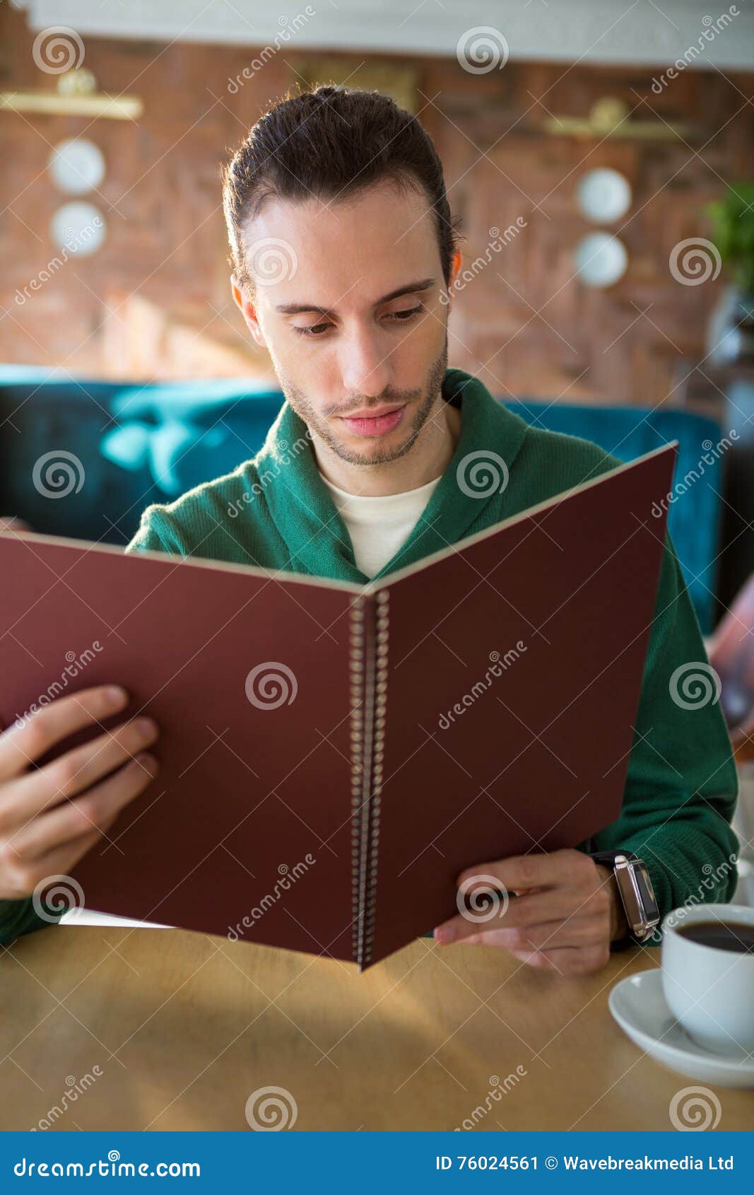Man looking at menu stock image. Image of lifestyle, handsome - 76024561