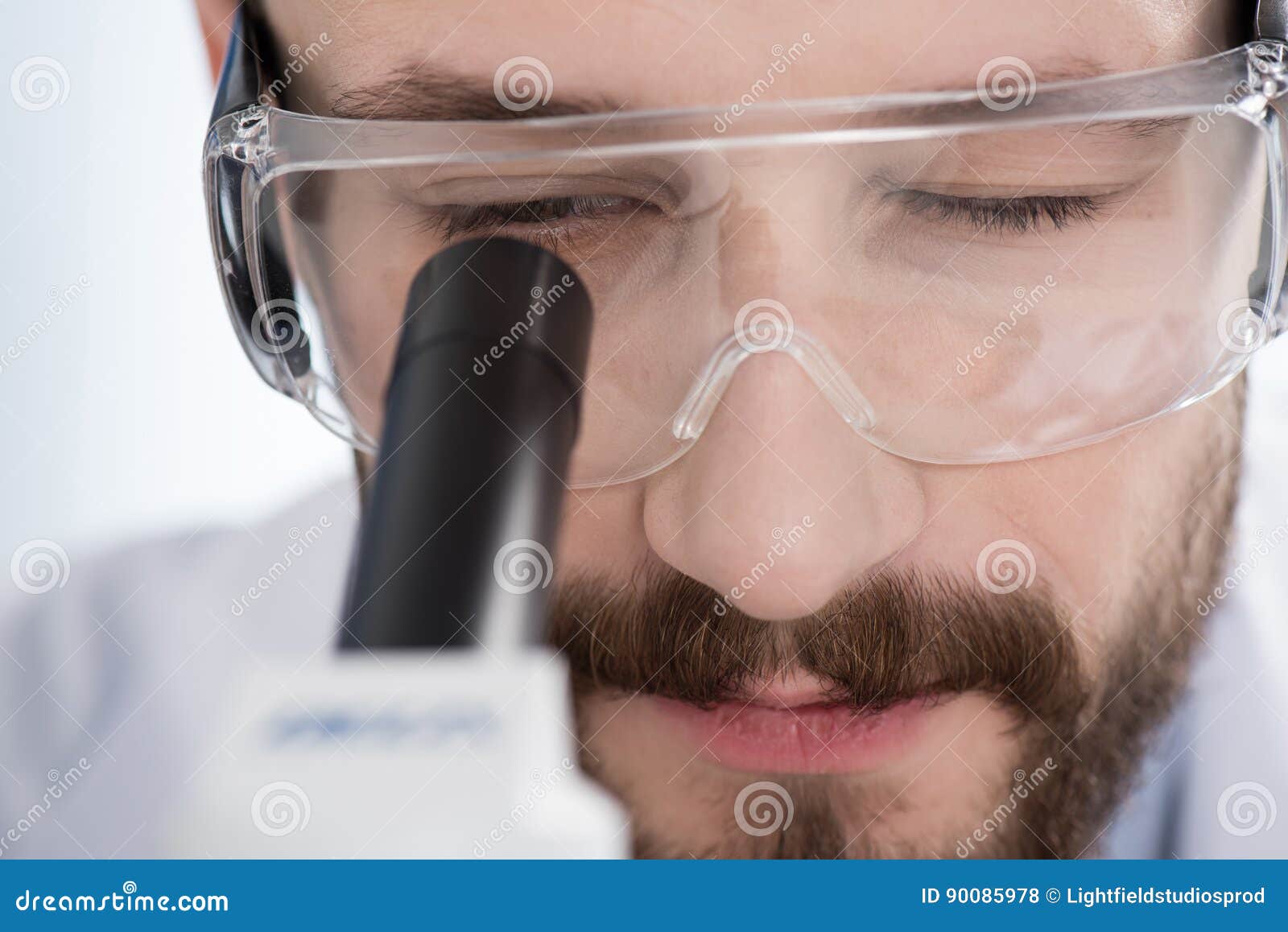 Man looking in microscope stock photo. Image of analysis - 90085978