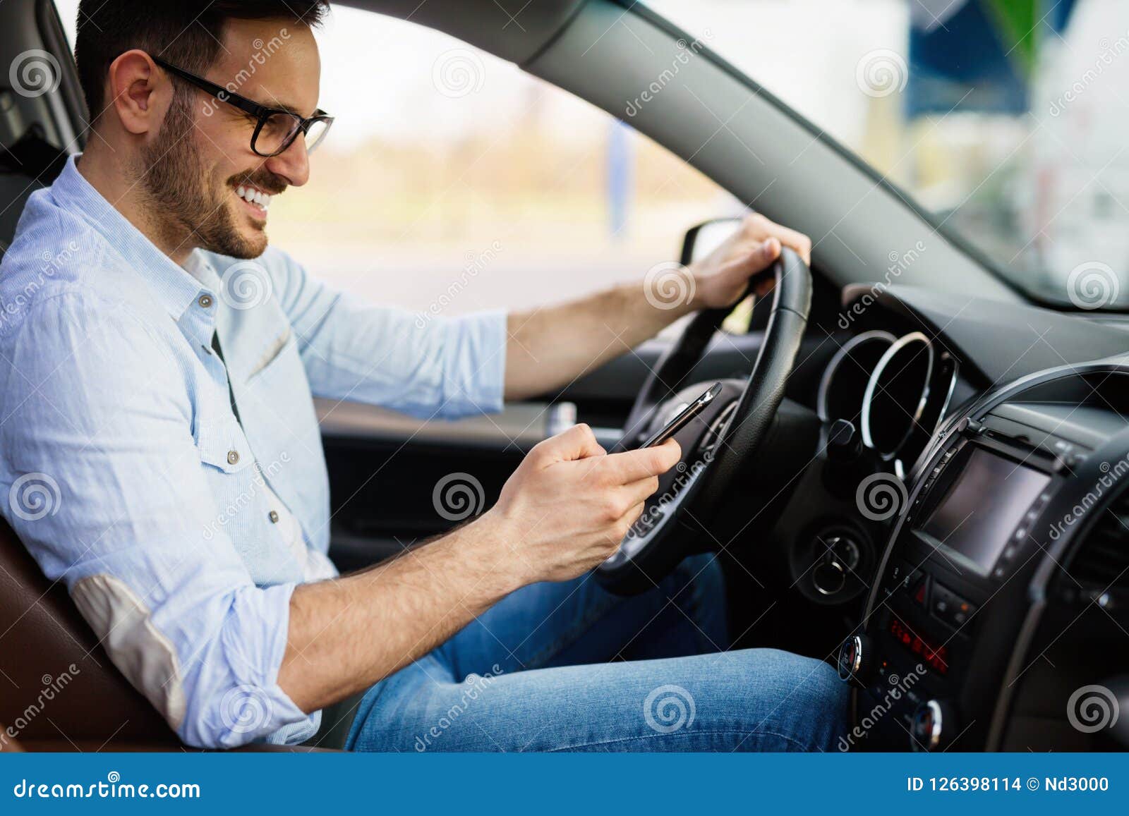 Man Looking at Mobile Phone while Driving Stock Photo - Image of auto ...