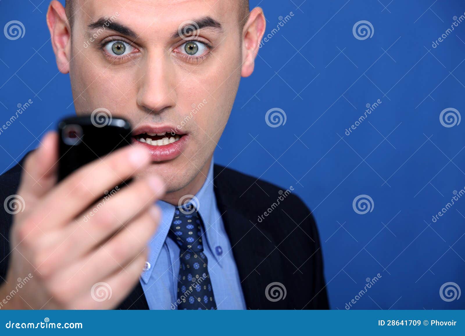 Man Looking at Mobile Telephone Stock Image - Image of male, grimace ...