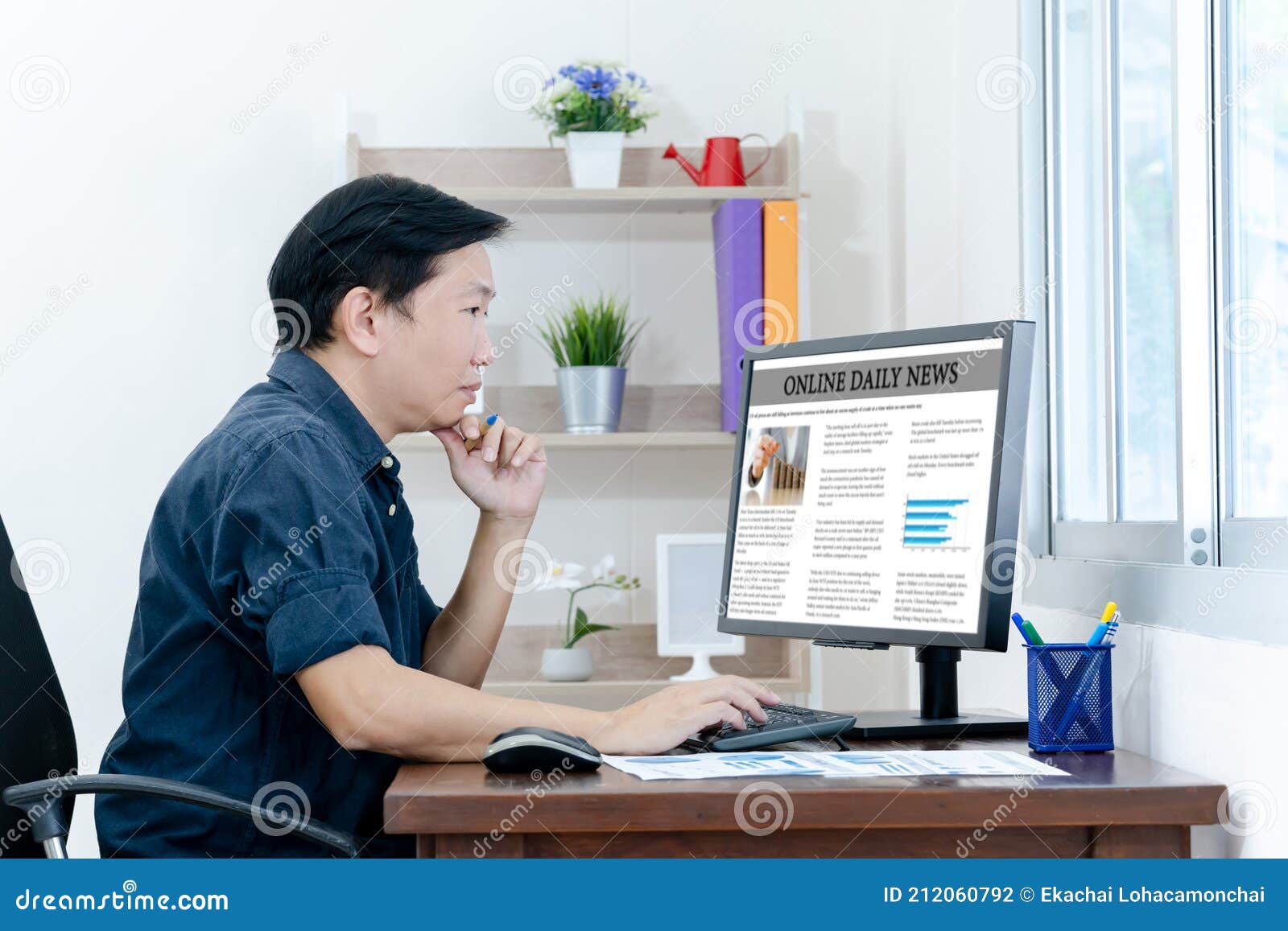 Man Looking at News in Online Newspaper on Computer Stock Photo - Image ...