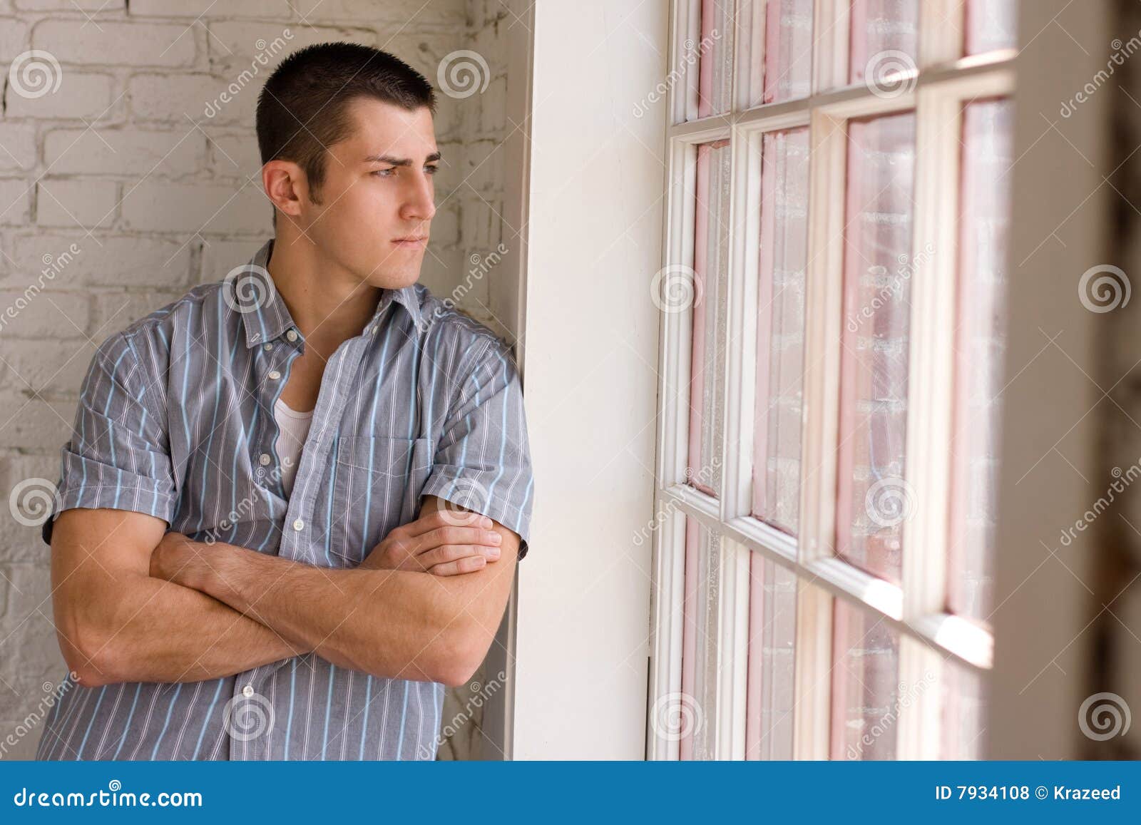 Man looking out window stock photo. Image of muscle, gorgeous - 7934108