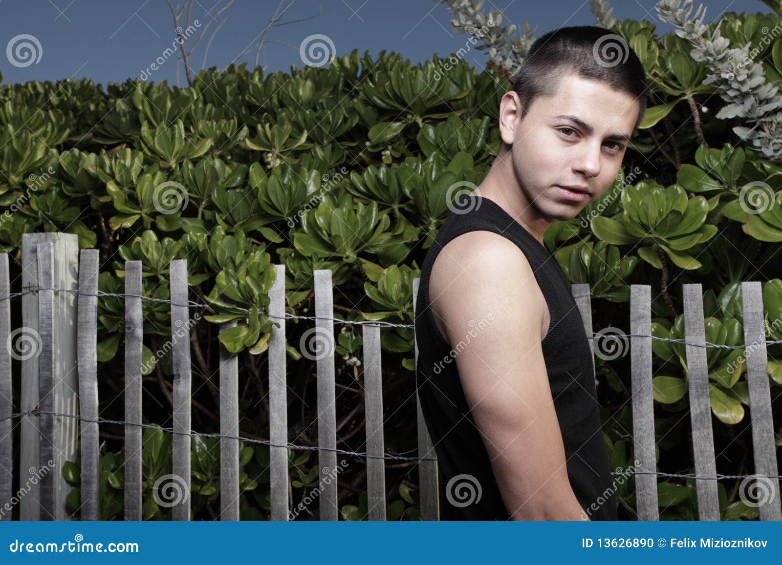 Man Looking Over His Shoulder Stock Photo - Image of fence, person ...