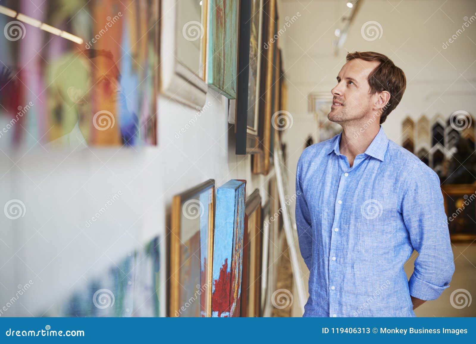 Man Looking at Paintings in Art Gallery Stock Image - Image of relaxed ...