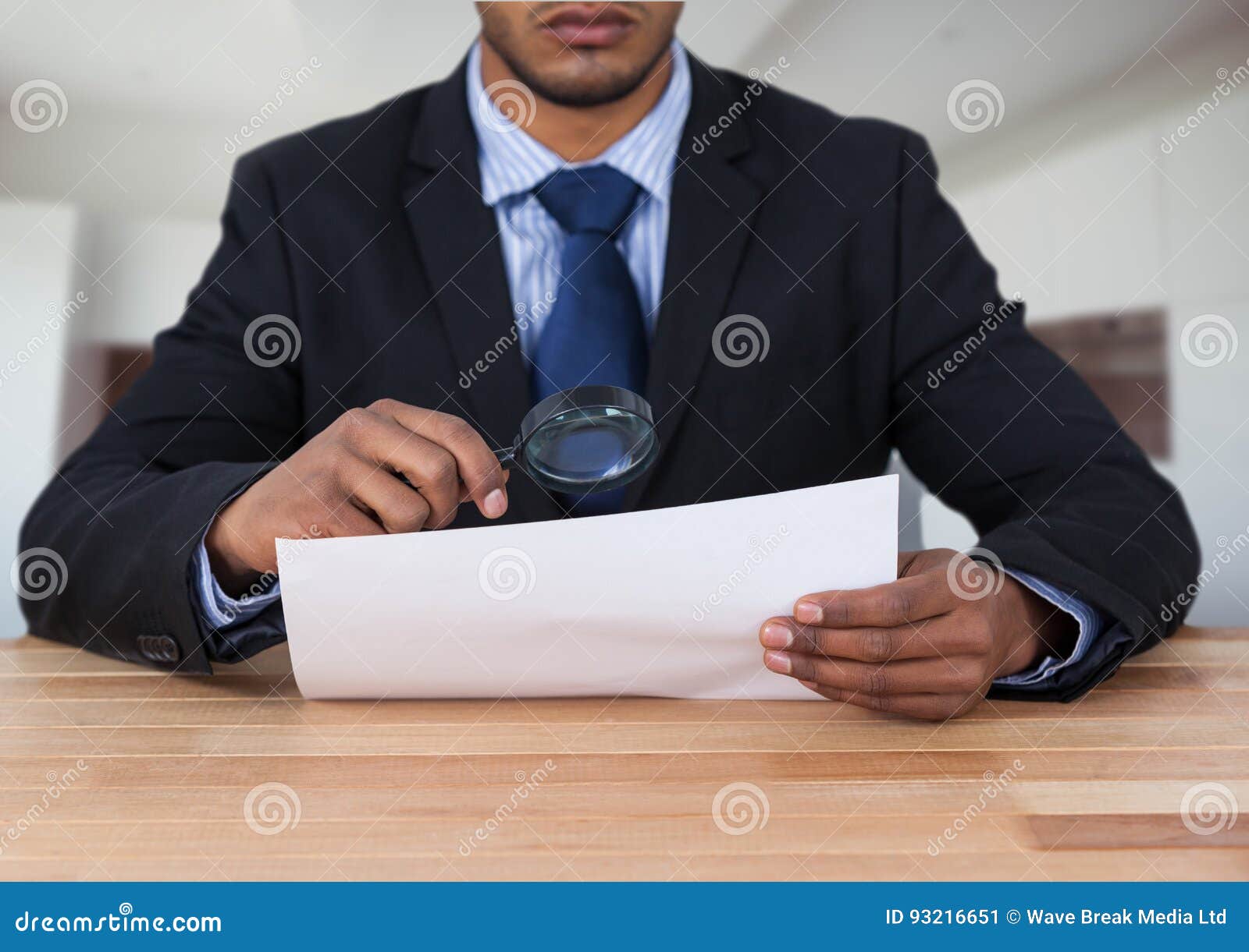 Man Looking at Paper with Magnifying Glass at Desk Stock Image - Image ...