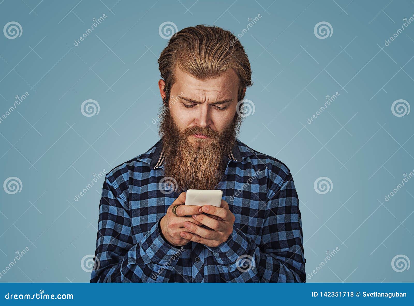 Man Looking Perplexed and Skeptical while Using Cellphone Stock Photo ...