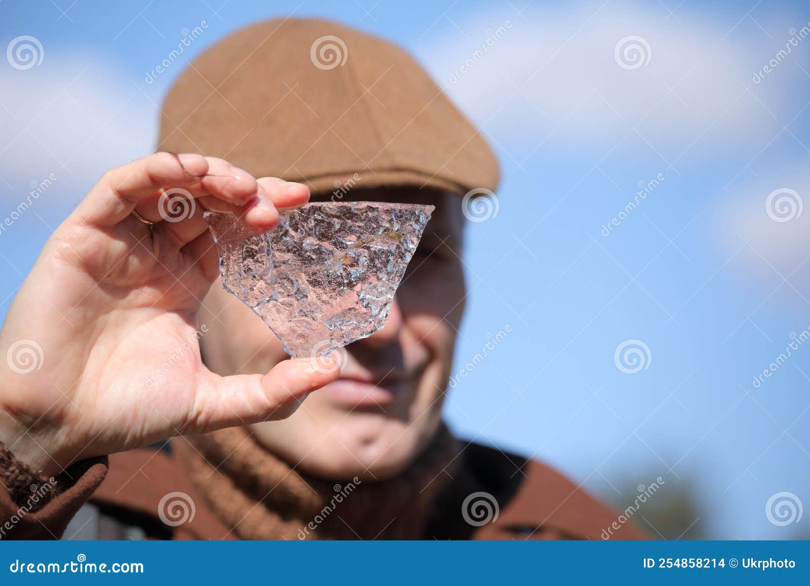 Man Looking through a Piece of Ice Stock Photo - Image of adult, good ...
