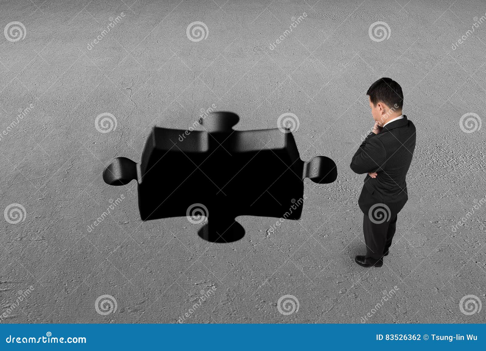 Man Looking at Puzzle Shape Hole on Concrete Ground Stock Photo - Image ...