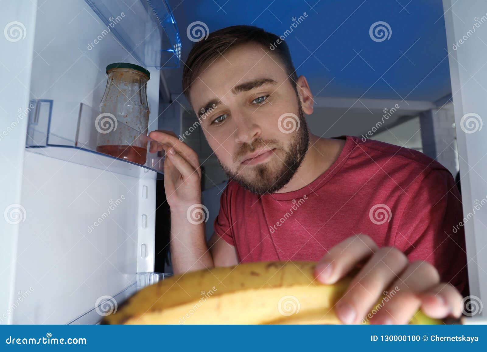 Man Looking into Refrigerator and Choosing Products Stock Photo - Image ...