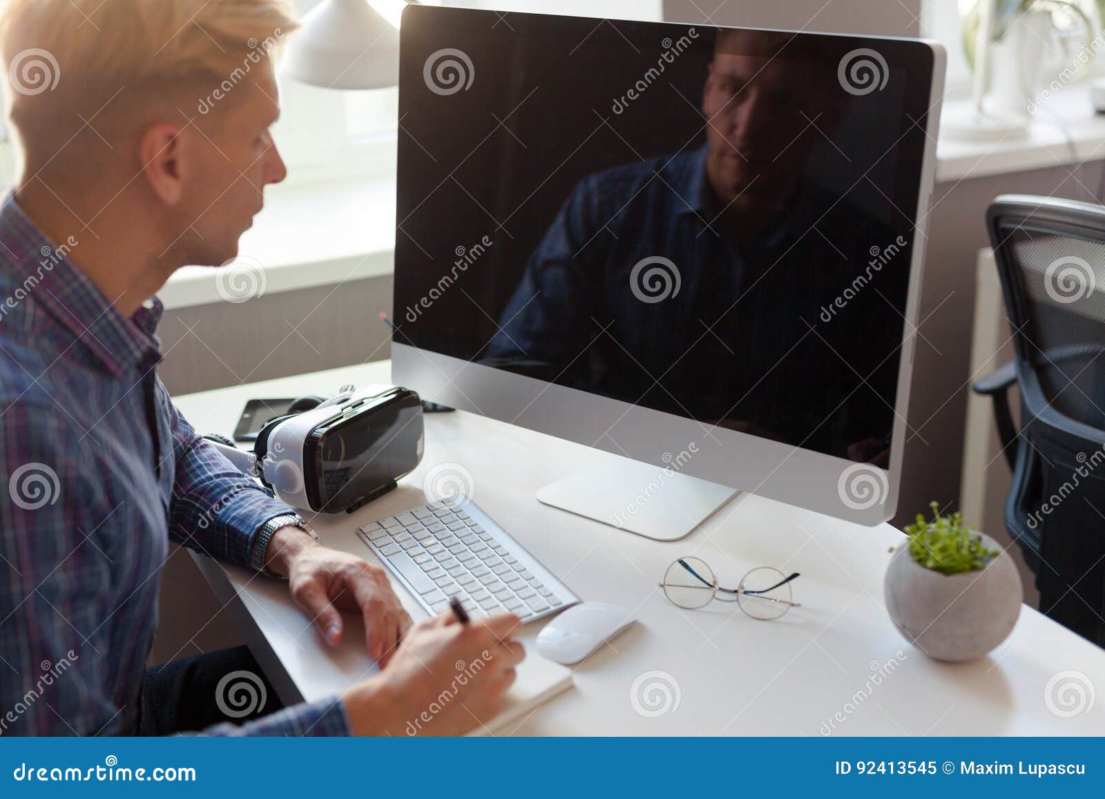 Man Looking at Screen and Writing Stock Image - Image of indoors ...