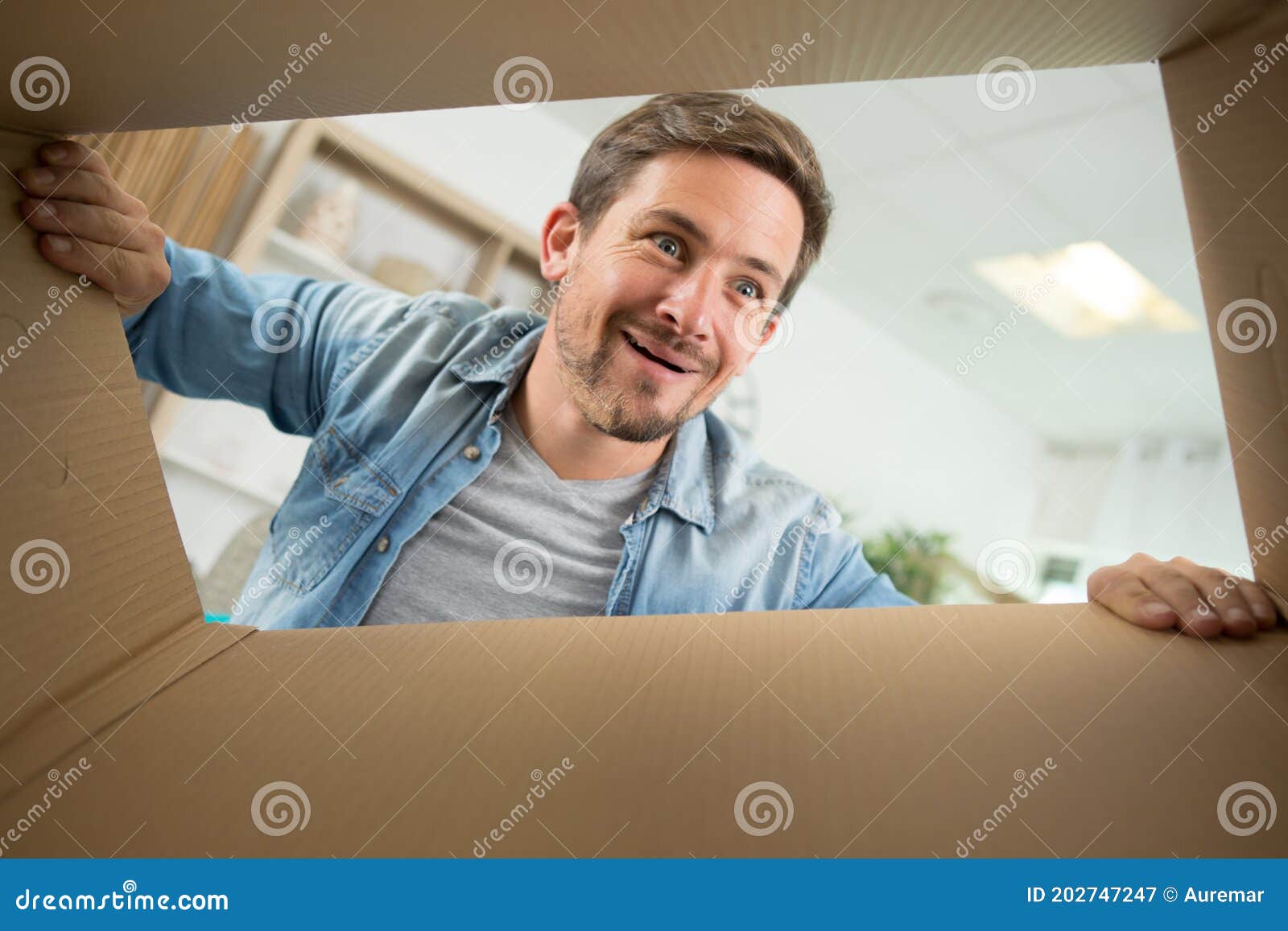 Man Looking at Something Inside Box Stock Image - Image of closeup ...