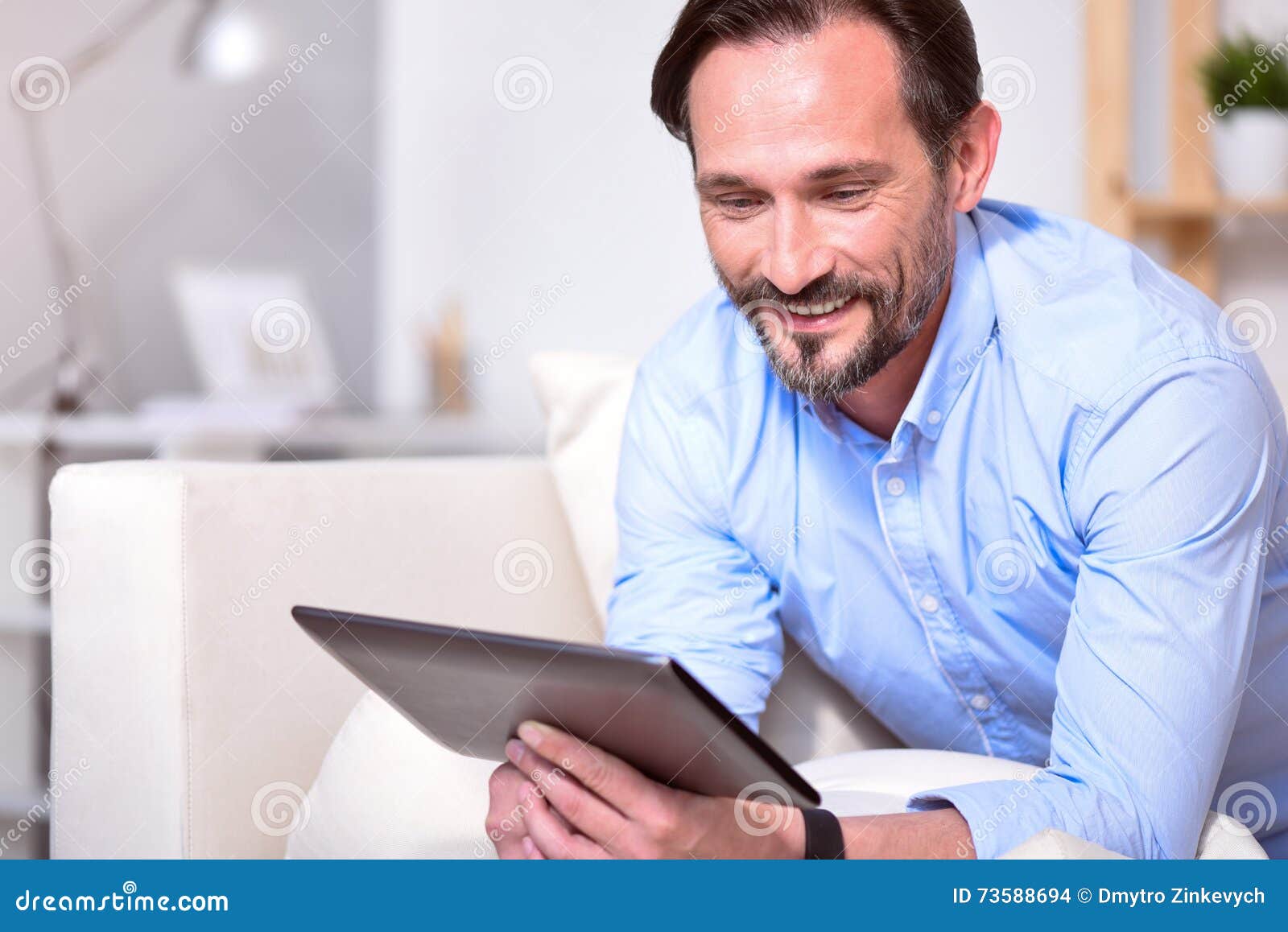 Man looking at the tablet stock photo. Image of indoor - 73588694