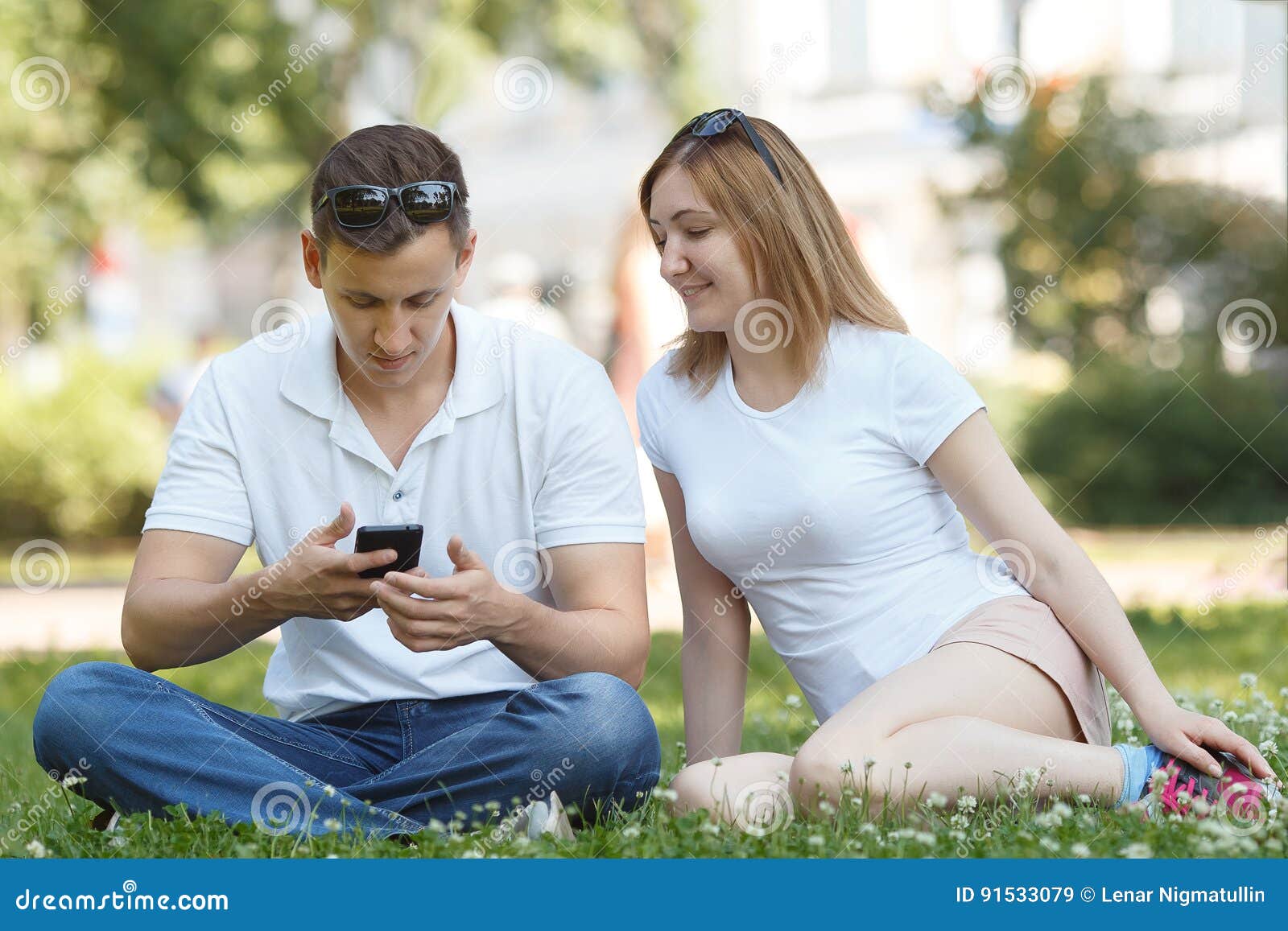 Man Looking at Their Mobile Phone while on a Date Stock Image - Image ...