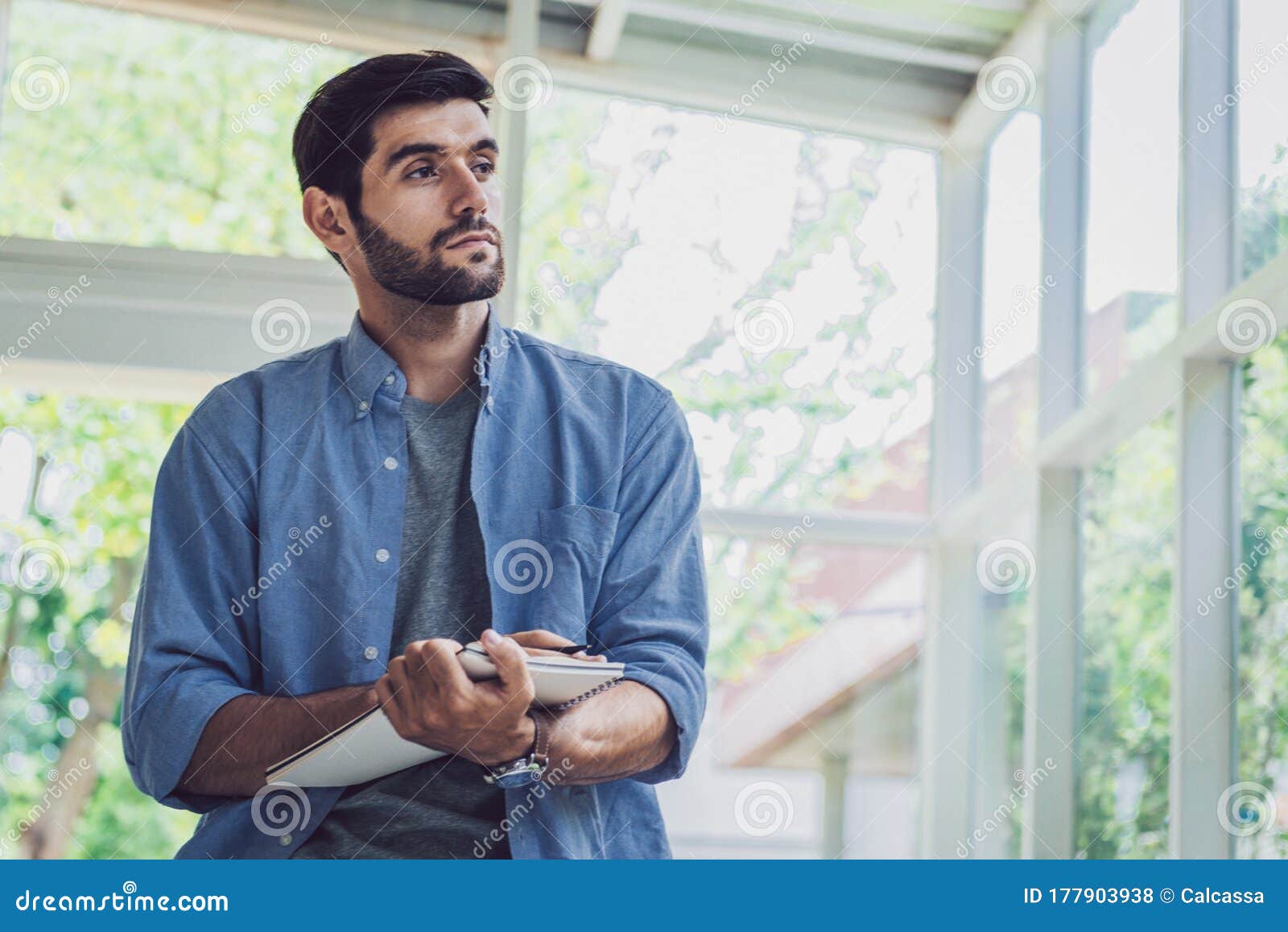 A Man Thinking and Writing His Idea at Note Book while Working at Home ...