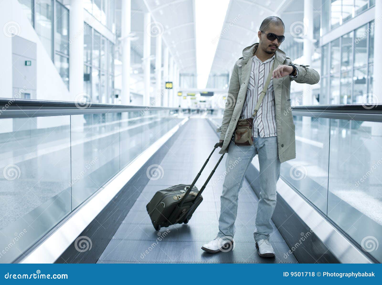 Man looking at time stock photo. Image of traveling, airport - 9501718