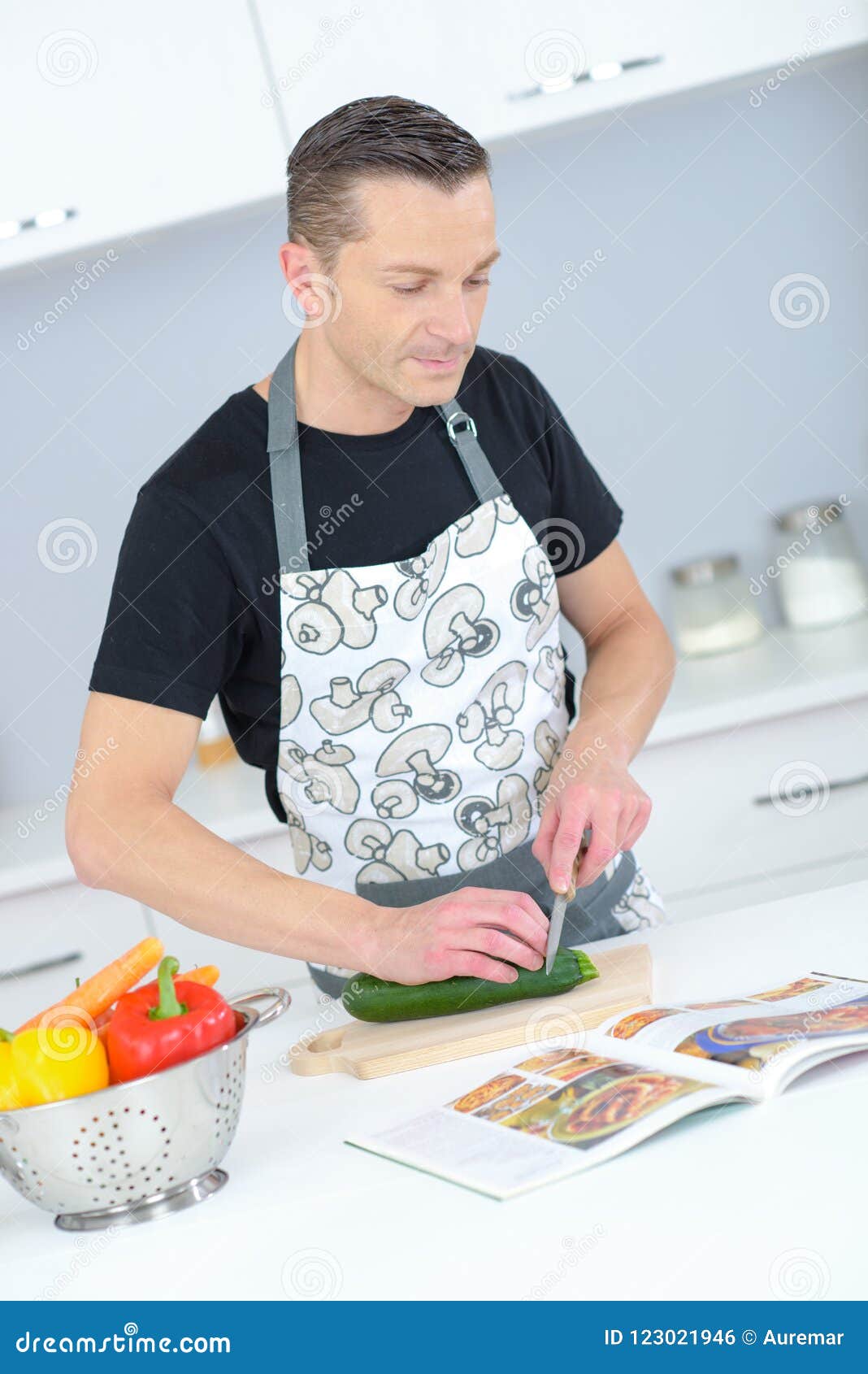 Man Looking Up Recipe in Kitchen Stock Photo - Image of island, people ...