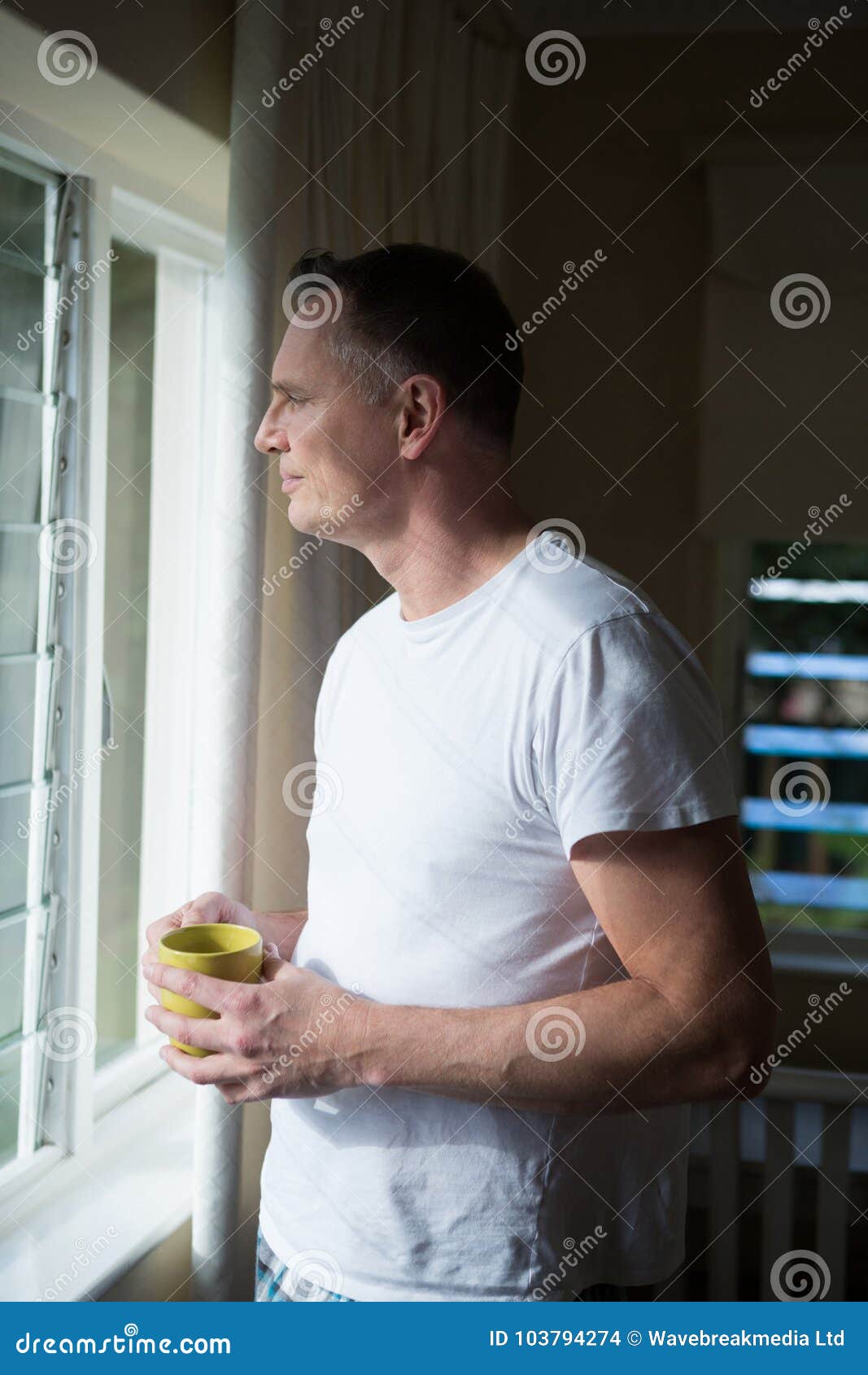 Man Looking through Window while Having Cup of Coffee Stock Photo ...