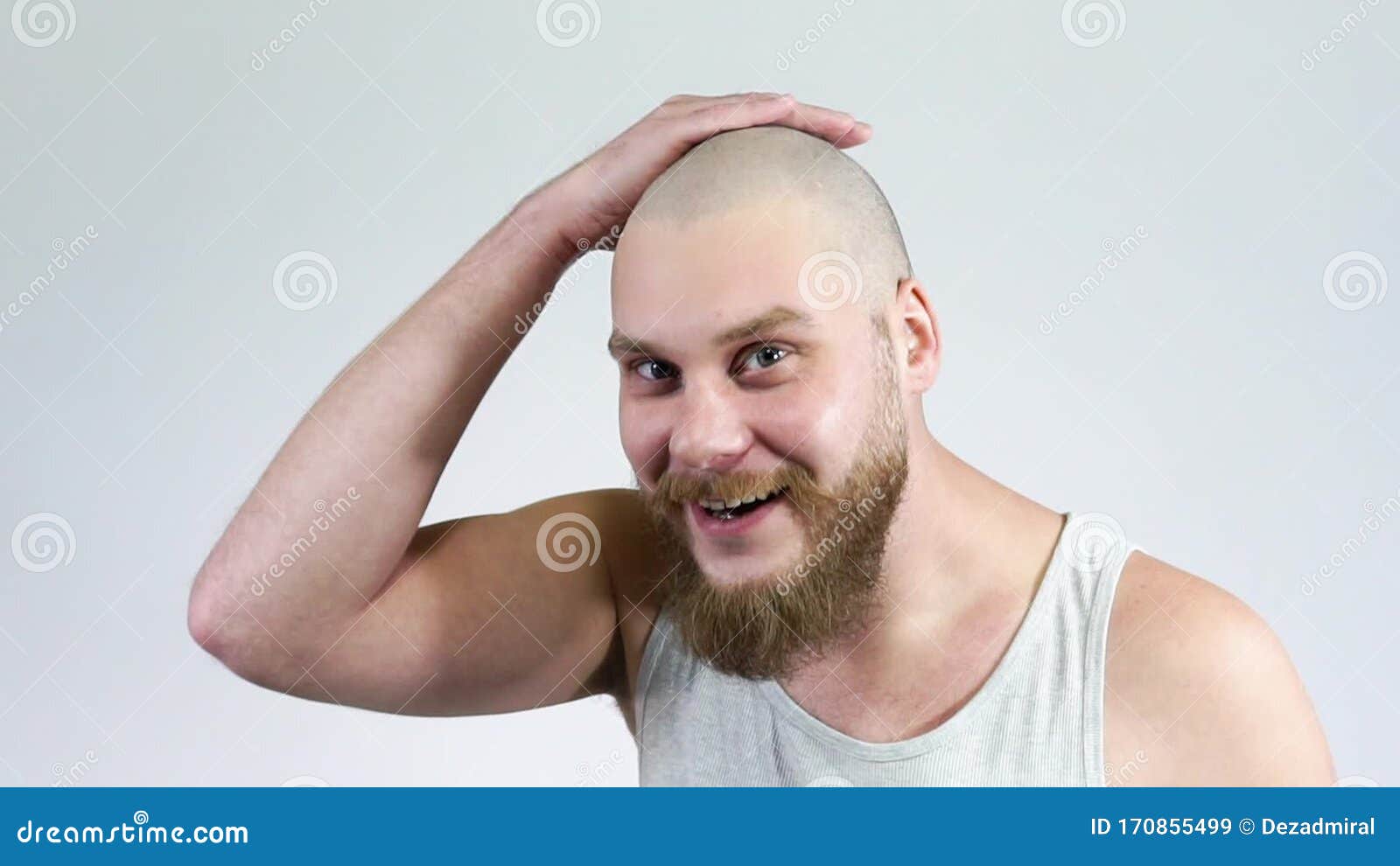 A Man Looks in the Mirror at the Reflection of the Bald Head and ...