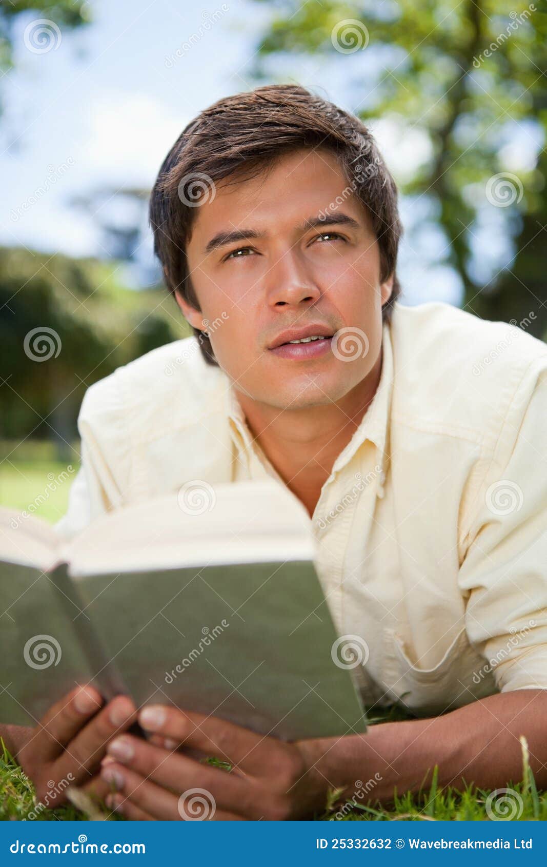 Man Looks To the Distance while Reading a Book Stock Photo - Image of ...