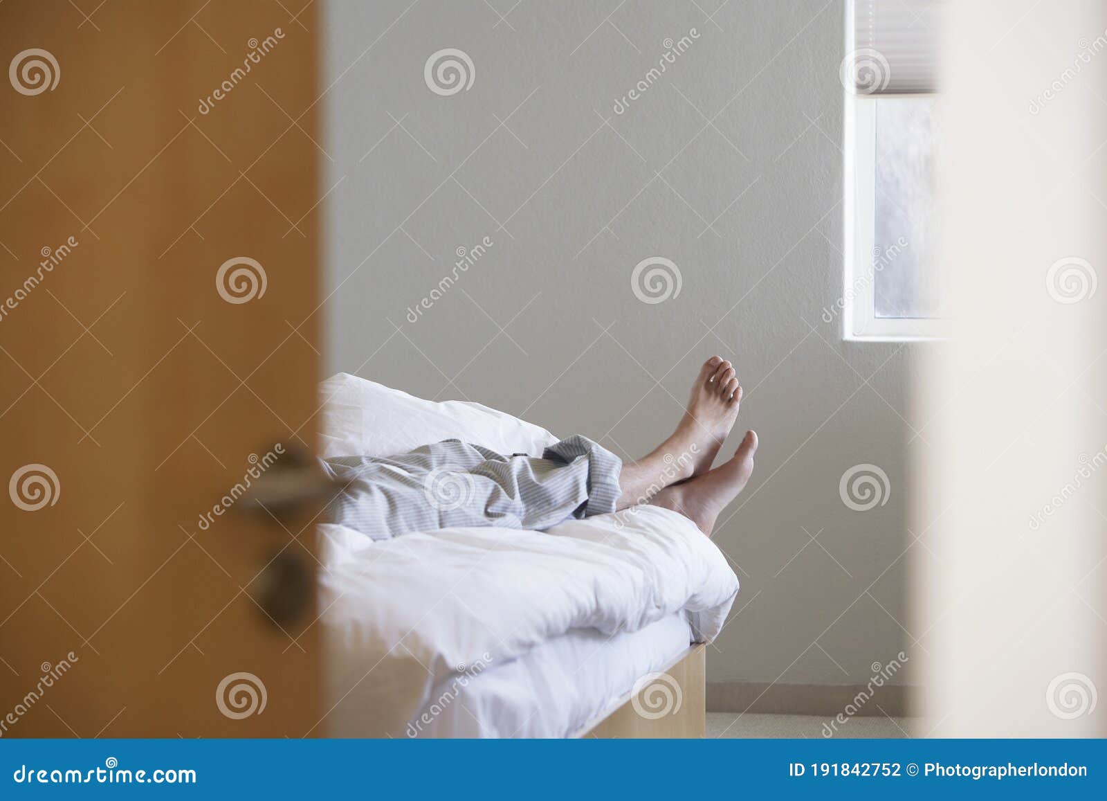 Man Lying Across Bed Low Section Stock Photo - Image of calm, lying ...