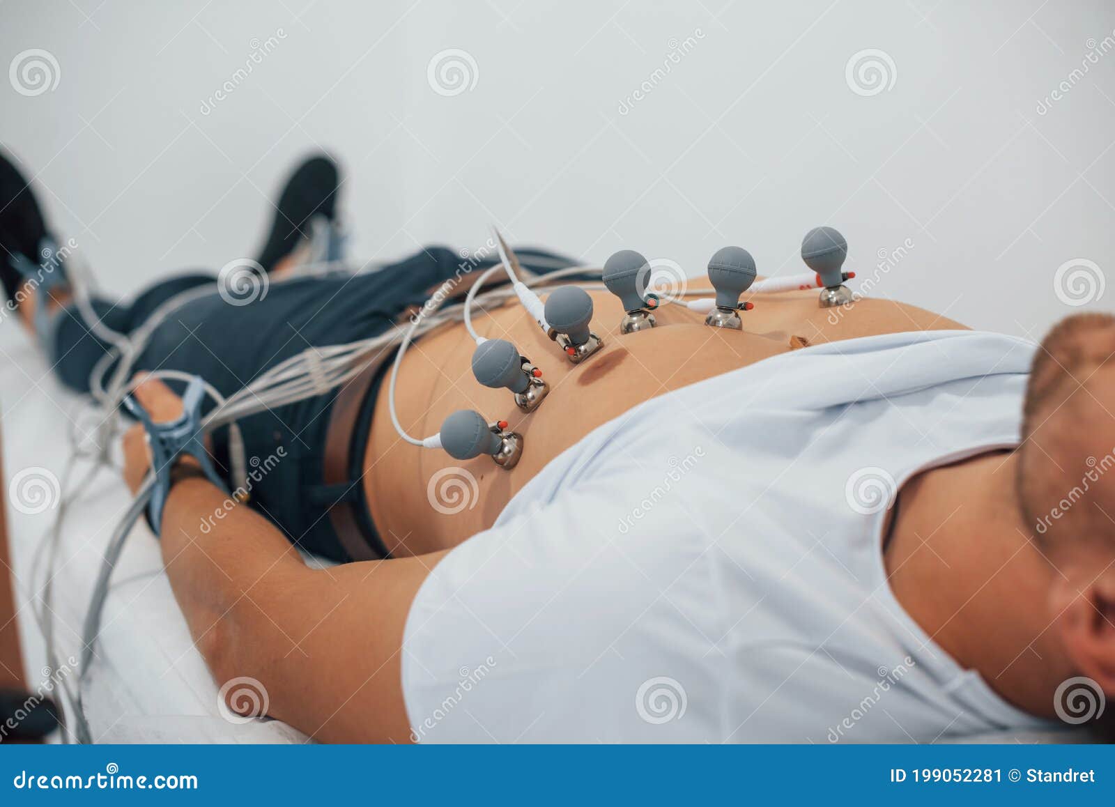 Man Lying on the Bed in the Clinic and Getting Electrocardiogram Test ...