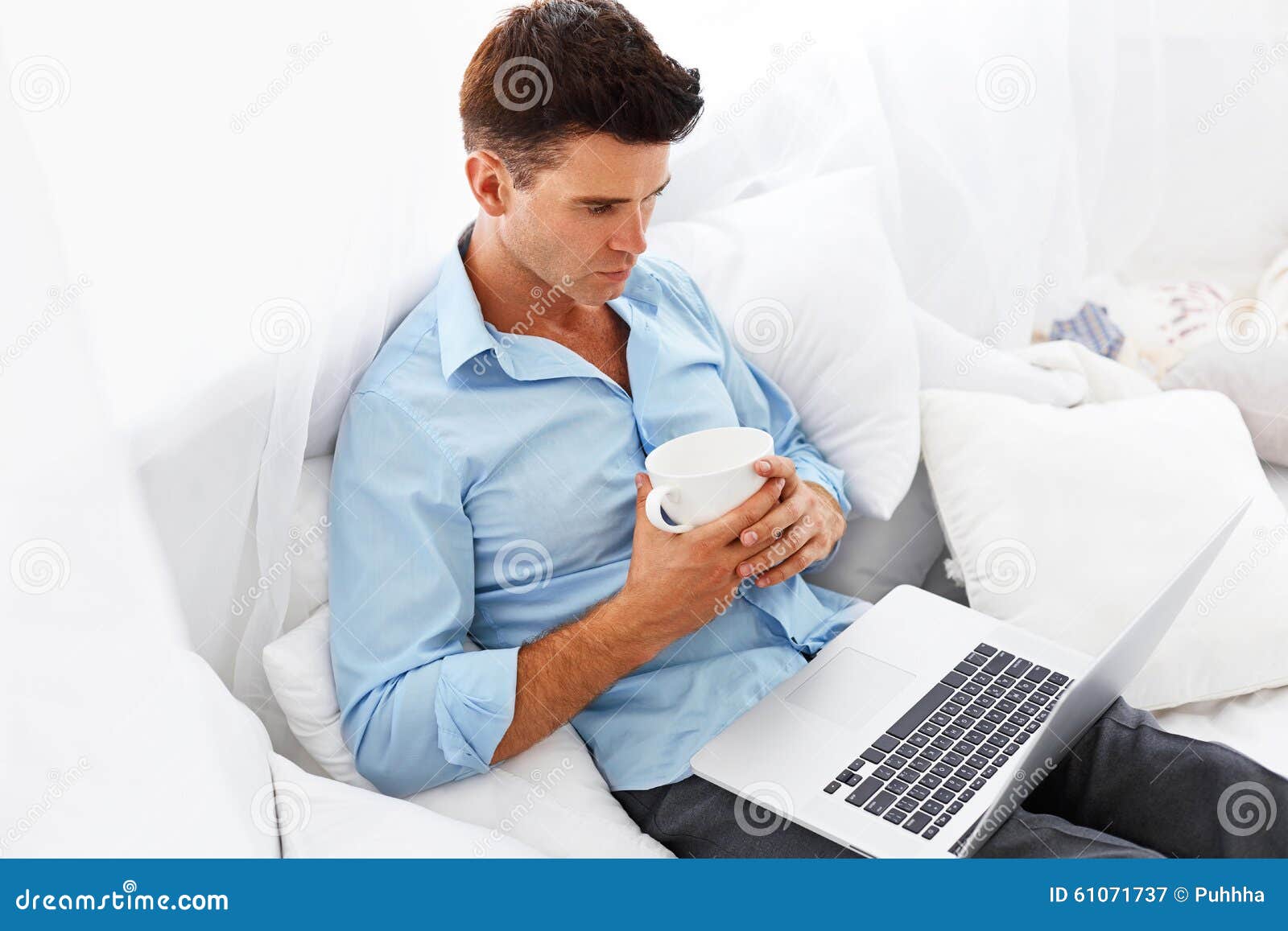 Man Lying in Bed with His Computer, Drinking Coffee. Stock Image ...