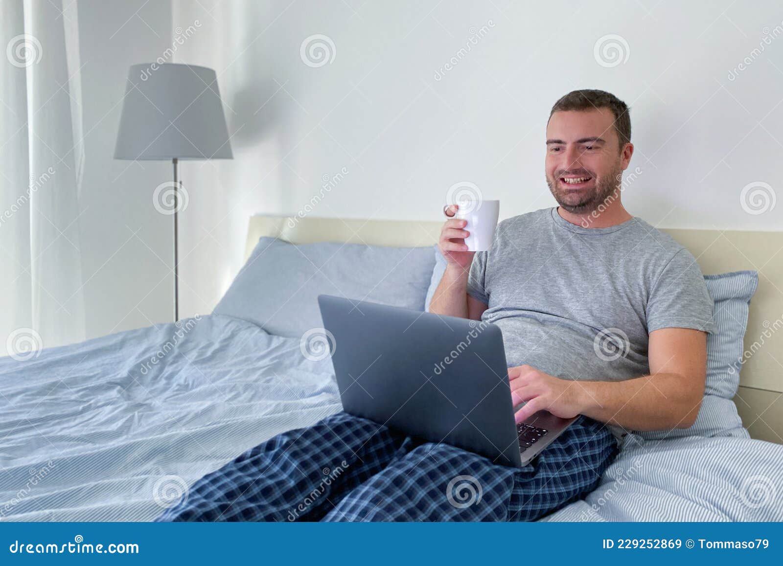 One Man is Working with Computer in Bed for Remote Work Stock Image ...
