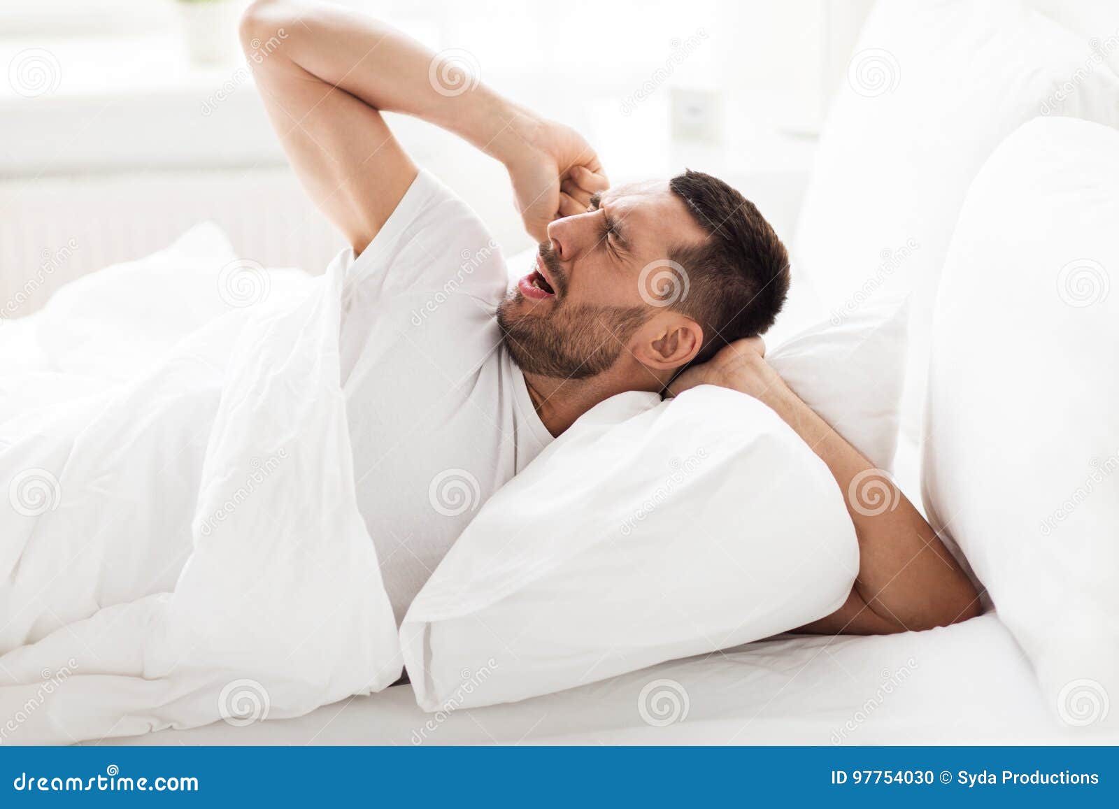 Man lying in bed at home stock photo. Image of resting - 97754030