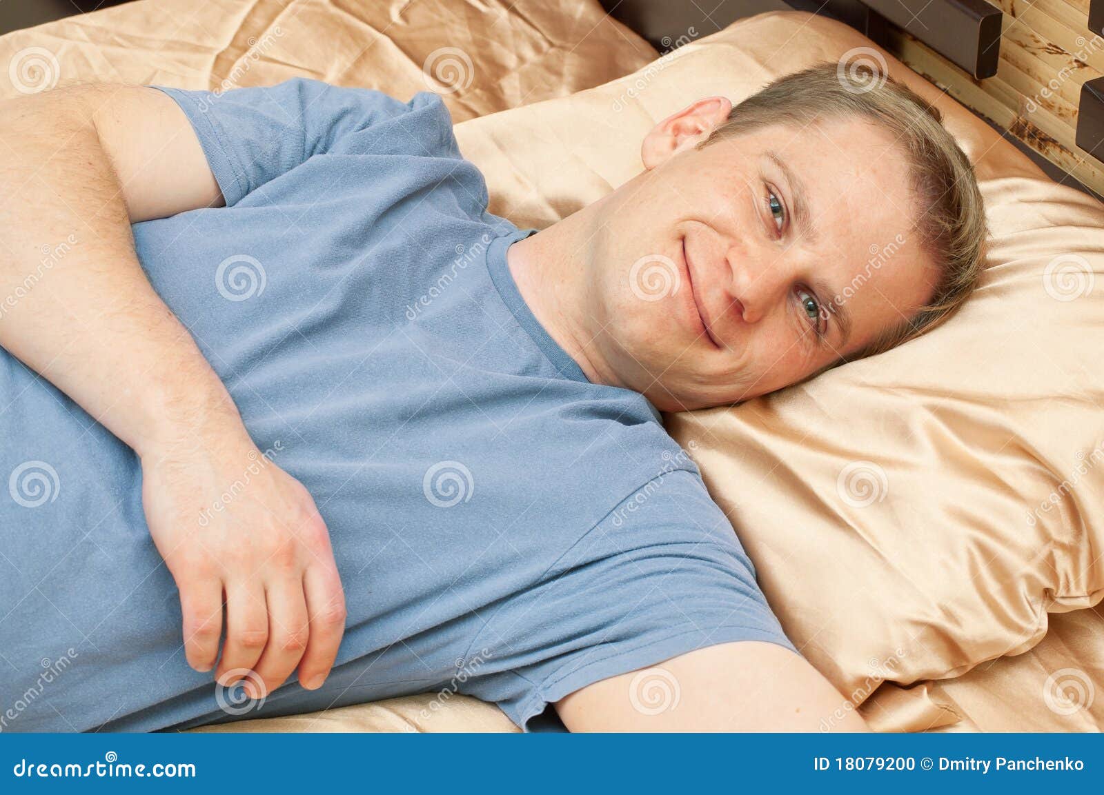 Man Lying in Bed and Smiling Stock Photo - Image of living, looking ...