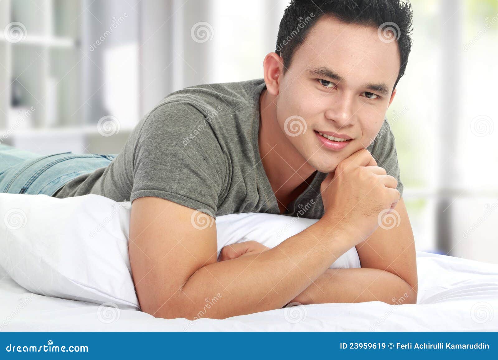 Man lying in bed smiling stock image. Image of person - 23959619