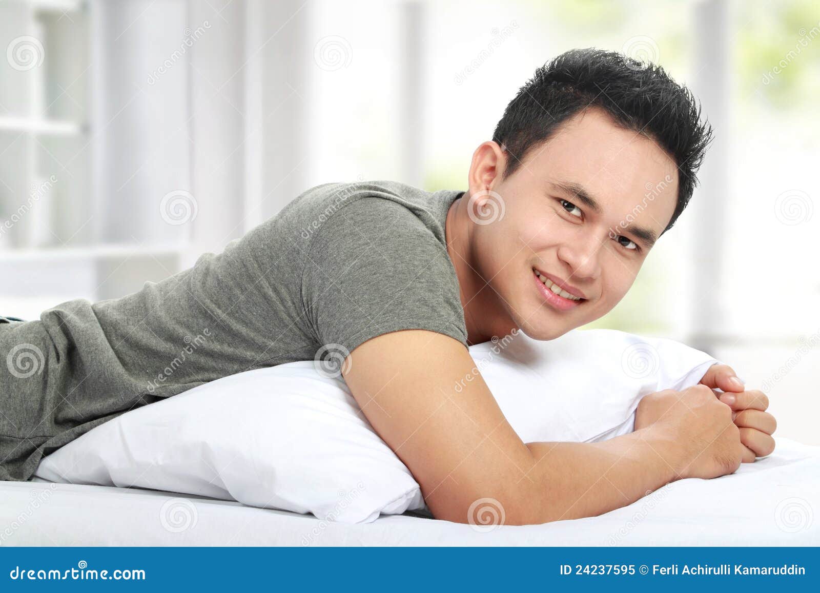 Man lying in bed smiling stock image. Image of horizontal - 24237595