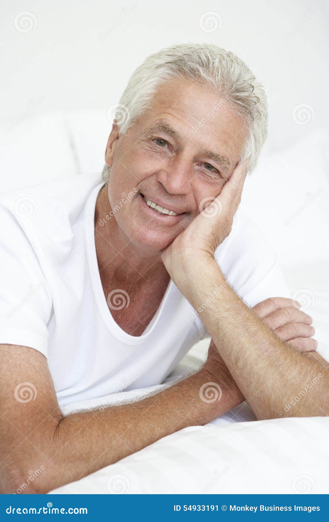 Man lying in bed smiling stock image. Image of happy - 54933191