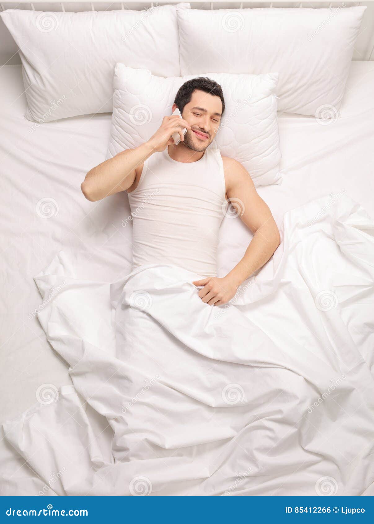 Man Lying in Bed and Talking on Phone Stock Photo - Image of attractive ...