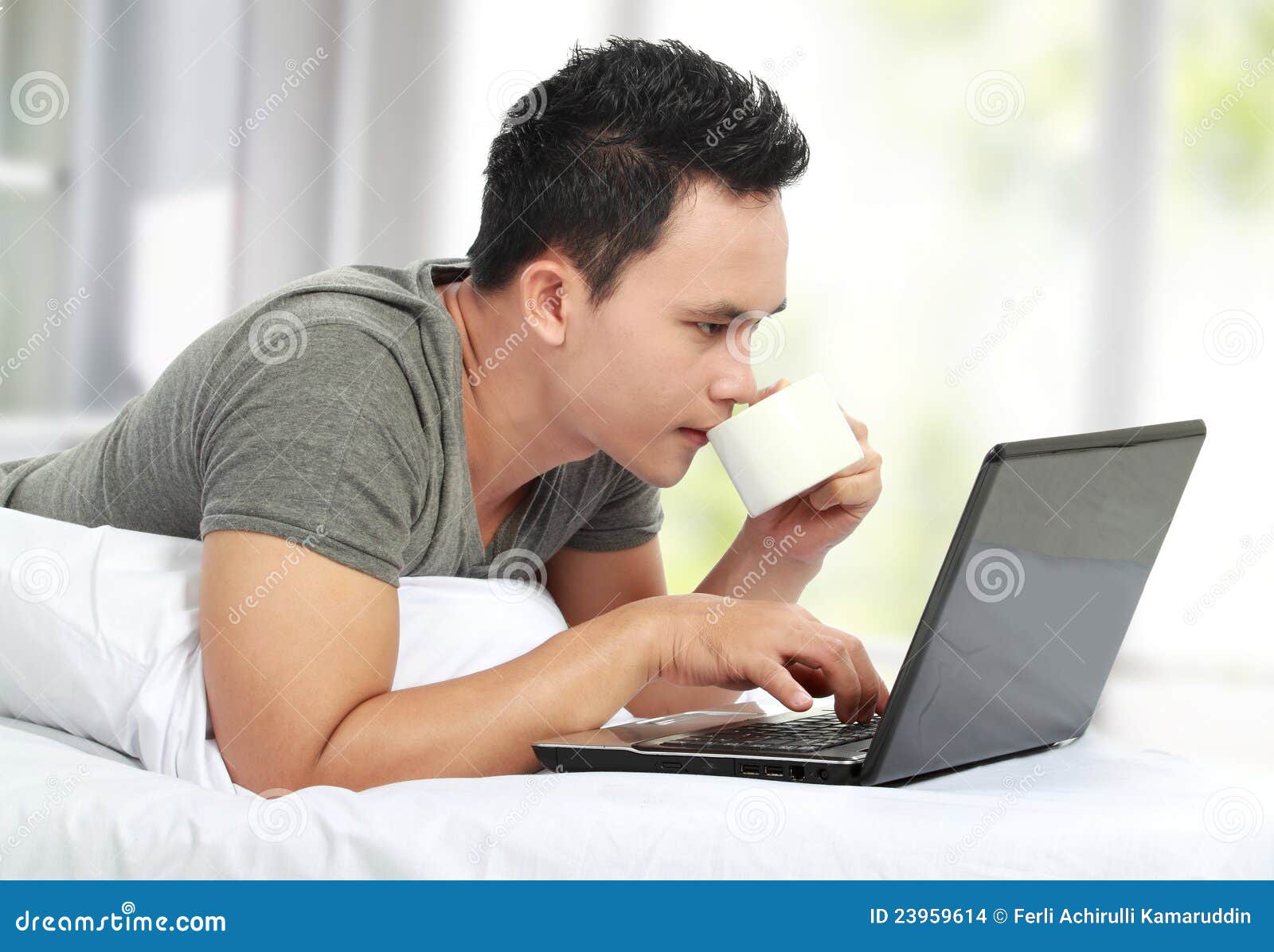 Man Lying on a Bed and Using a Laptop Computer Stock Photo - Image of ...